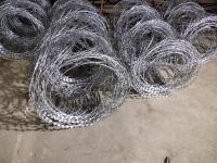 China Hot Dipped Galvanized BTO-18 Concertina Coil Wire Flat Wrap Razor Barbed Wire for sale