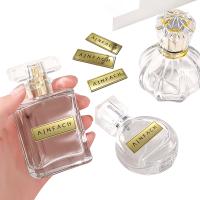 China Custom Aluminum Labels 3D Embossed Gold Finish Self Adhesive Metal Sticker 59x15mm for Perfume Bottles for sale