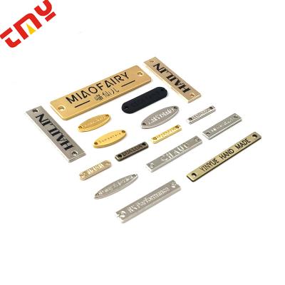 China Custom 2 Holes Engraved Metal Plate Logo Sewing Zinc Alloy Garment Label Tags 1mm Thickness for Clothing for sale