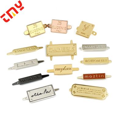 China Custom Zinc Alloy Metal Logo Labels Name Tags for Bags Clothes 0.5-1mm Thick for sale