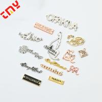 China Custom Zinc Alloy Metal Logo Labels Name Tags for Bags Clothes 0.5-1mm Thick for sale