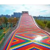 China Commercial Large Rainbow Dry Slide Land Slide Wheeled Slider Block  Expansion Ride Campsites rainbow slide on the hill for sale