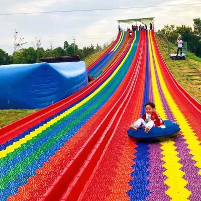 China Commercial Large Rainbow Dry Slide Land Slide Wheeled Slider Block  Expansion Ride Campsites rainbow slide on the hill for sale