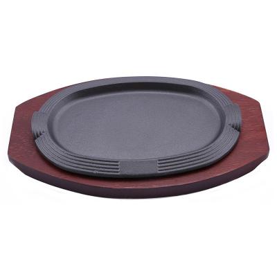 China Oval Cast Iron Sizzler Plate 27x17cm with Wooden Base for Home Restaurant Use for sale
