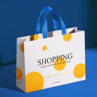 China Custom Logo White Coated Shipping Paper Bags With Handles for sale