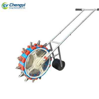 China Iron Manual Seeder Machine 7kg Capacity Hand Push Planter for Precise Sowing for sale
