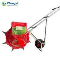 China Steel Manual Seeder Machine Push Seeder 7kg Seed Box Capacity Adjustable Nozzle Spacing for sale