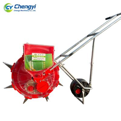 China Steel Manual Seeder Machine Push Seeder 7kg Seed Box Capacity Adjustable Nozzle Spacing for sale