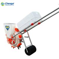 China Iron Manual Seeder Machine With Fertilizing Mechanical Push Planter Durable Dual Purpose Farm Device for sale