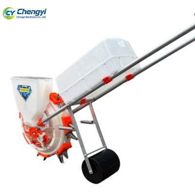 China Iron Manual Seeder Machine With Fertilizing Mechanical Push Planter Durable Dual Purpose Farm Device for sale