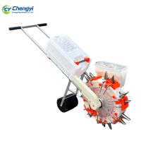 China Iron Manual Seeder Machine With Fertilizing Mechanical Push Planter Durable Dual Purpose Farm Device for sale