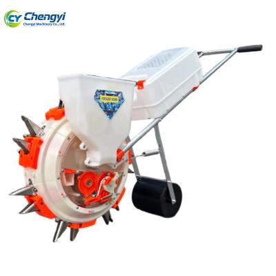 China Manual Seeder Machine with Fertilizing Walking Row Drill 14.5kg Portable Combined Sowing Equipment for sale