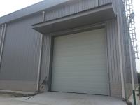 China Prefab Steel Workshop with Electric Rolling Shutter - Grade 12 Wind Resistance, 50-Year Lifespan, -50°C to +50°C Temperature Range for sale