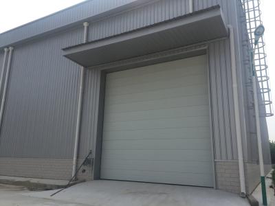 China Prefab Steel Workshop with Electric Rolling Shutter - Grade 12 Wind Resistance, 50-Year Lifespan, -50°C to +50°C Temperature Range for sale