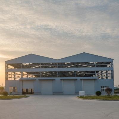 China Double Slope Roof Steel Structure Warehouse Built Using Q420B Steel Material Designed To Last More Than 50 Years Providing Storage Space for sale