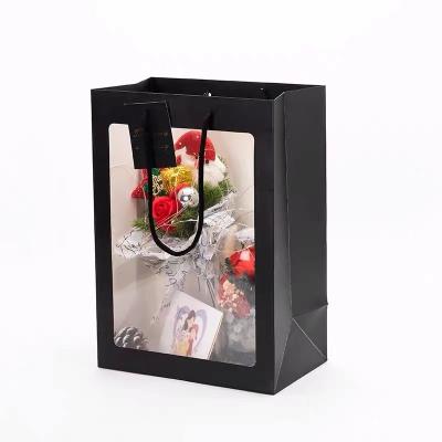 China Custom 250gsm C1S Paper Jewelry Bag with Window and Nylon Handle UV Stamp for sale
