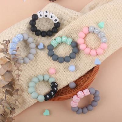 China Bpa Free Natural Rubber Silicone Pacifier  Baby Letter Chew Teething Teether Toy for sale