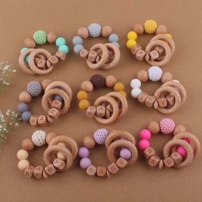 China Baby Teething Toys Rattle Soft Bpa Free Cartoon Wood Baby Teether Ring Kids Food Grade Baby Silicone Teether for sale