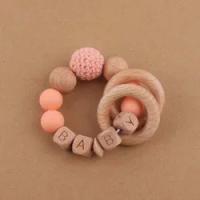 China Baby Teething Toys Rattle Soft Bpa Free Cartoon Wood Baby Teether Ring Kids Food Grade Baby Silicone Teether for sale