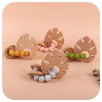 China Food Grade Silicone Teether Toy Rattle Soft BPA Free Cartoon Wood Teether Ring for sale