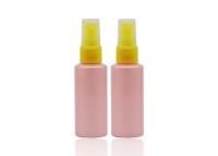 China Flat Shoulder Pink PET 50ml Small Plastic Spray Bottles Refillable With Yellow Pump for sale