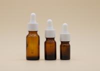 China Amber Empty Essential Oil Bottles Color Coating White Ceramic Dropper Bottle for sale