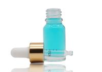 China Clear Color 15ml Round Shape Cosmetic Glass Bottle With Gold Aluminum Dropper for sale