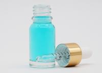 China Clear Color 15ml Round Shape Cosmetic Glass Bottle With Gold Aluminum Dropper for sale