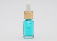 China Clear Color 15ml Round Shape Cosmetic Glass Bottle With Gold Aluminum Dropper for sale