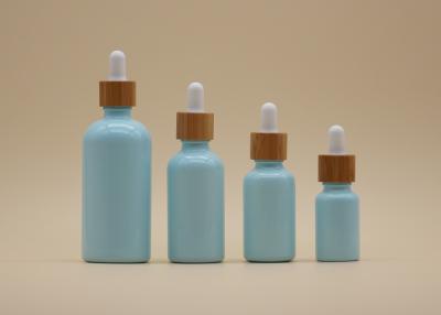 China Color Coating Sky Blue 15ml 30ml Essential Oil Bottles With Bamboo Dropper for sale