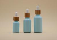 China Color Coating Sky Blue 15ml 30ml Essential Oil Bottles With Bamboo Dropper for sale