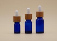 China Free Samples Blue Color Essential Oil Glass Bottles With Bamboo Dropper for sale