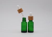 China Green Oil 18mm Cosmetic Glass Dropper Bottles With Bamboo Dropper Printing Pipette for sale