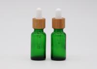 China Green Oil 18mm Cosmetic Glass Dropper Bottles With Bamboo Dropper Printing Pipette for sale