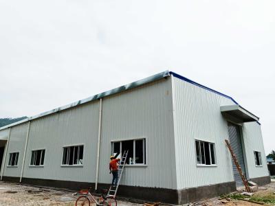 China Fireproof Steel Structure Building Warehouse with Electric Rolling Shutter Door 0.476mm Panel for sale