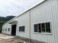 China Fireproof Steel Structure Building Warehouse with Electric Rolling Shutter Door 0.476mm Panel for sale