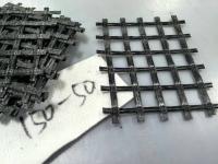 China Uniaxial 150-50 KN/M Woven Polyester Geogrid Railroad Subway And Highway Soil Reinforcement for sale