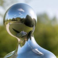 China Custom Mirror Polished Stainless Steel Contemporary Figure in a Flowing Coat for sale