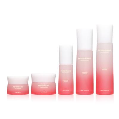 China Luxury Skin Care Cosmetic Packaging Set Red Gradient Glass Lotion Bottle for sale