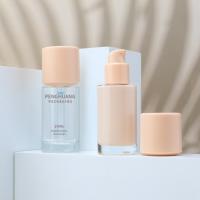 China Round Empty Liquid Foundation Bottles With Pump Cap Glass Skincare Packaging  30ml for sale