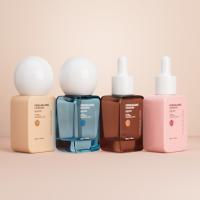 China Luxury Wholesale Foundation Bottles 30ML Round Ball Cap Thick Bottom Empty Liquid Foundation Bottles for sale