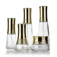 China 30ml 100ml 120ml Cosmetic Container Packaging Clear Glass With Gold Cap for sale