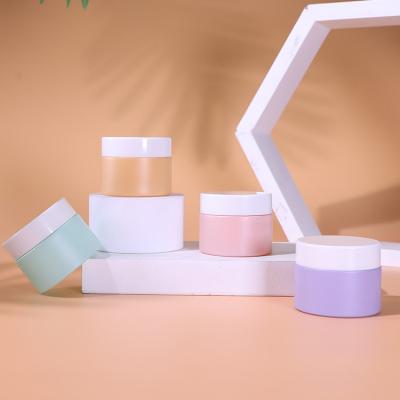 China 30g 50g Empty Glass Container Frosted Cream Jar With Plastic Cap painting color for sale
