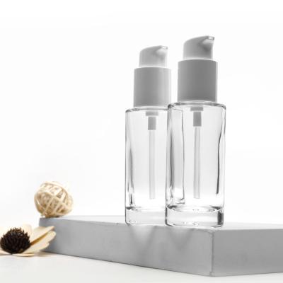China 30ml Empty Lotion Bottle Transparent Foundation Glass Serum Lock Pump Bottle for sale