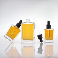 China Flat Square Serum Glass Dropper Bottles 30ml 50ml 100ml With Black Gold Collar for sale