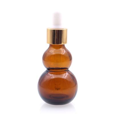 China Glass Essential Oil Bottle Amber color Cucurbit Shaped for sale