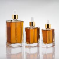China Custom Logo Clear Glass Bottle 30ml 50ml 100ml with Gold Dropper for sale