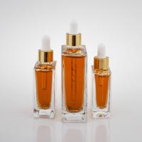 China Custom Logo Clear Glass Bottle 30ml 50ml 100ml with Gold Dropper for sale