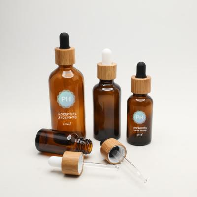 China Bamboo Collar Amber Oil Dropper Glass Bottle For Personal Care for sale