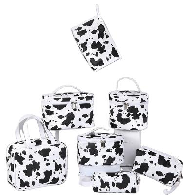 China Durable Wholesale Beauty PU Storage Bag Makeup Bag Cow Pattern Custom Cosmetic Bags And Cases for sale